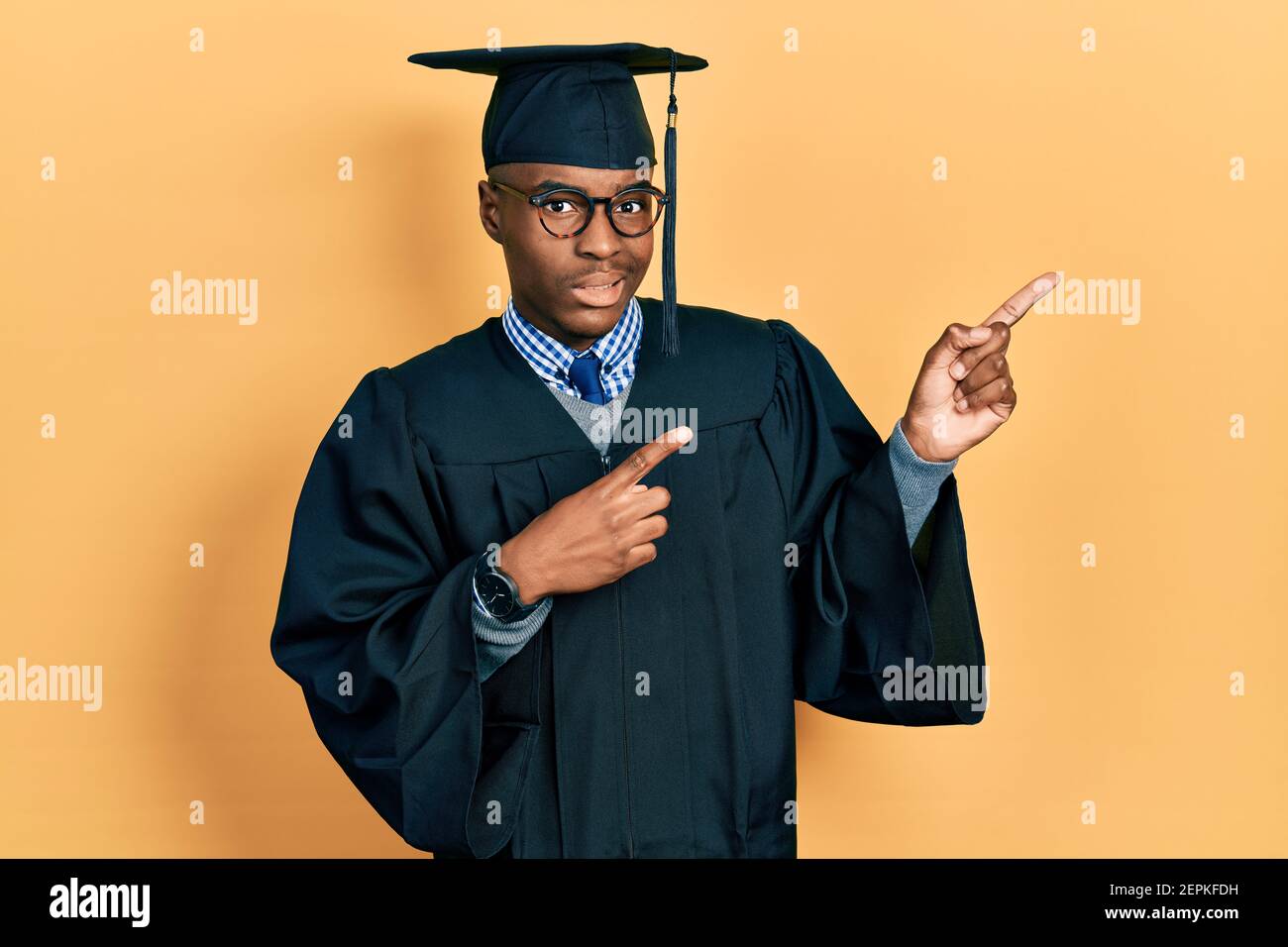Young african american man wearing graduation cap and ceremony robe ...
