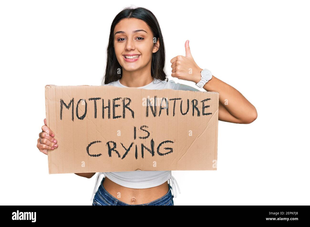 Young hispanic girl holding mother nature is crying protest cardboard ...