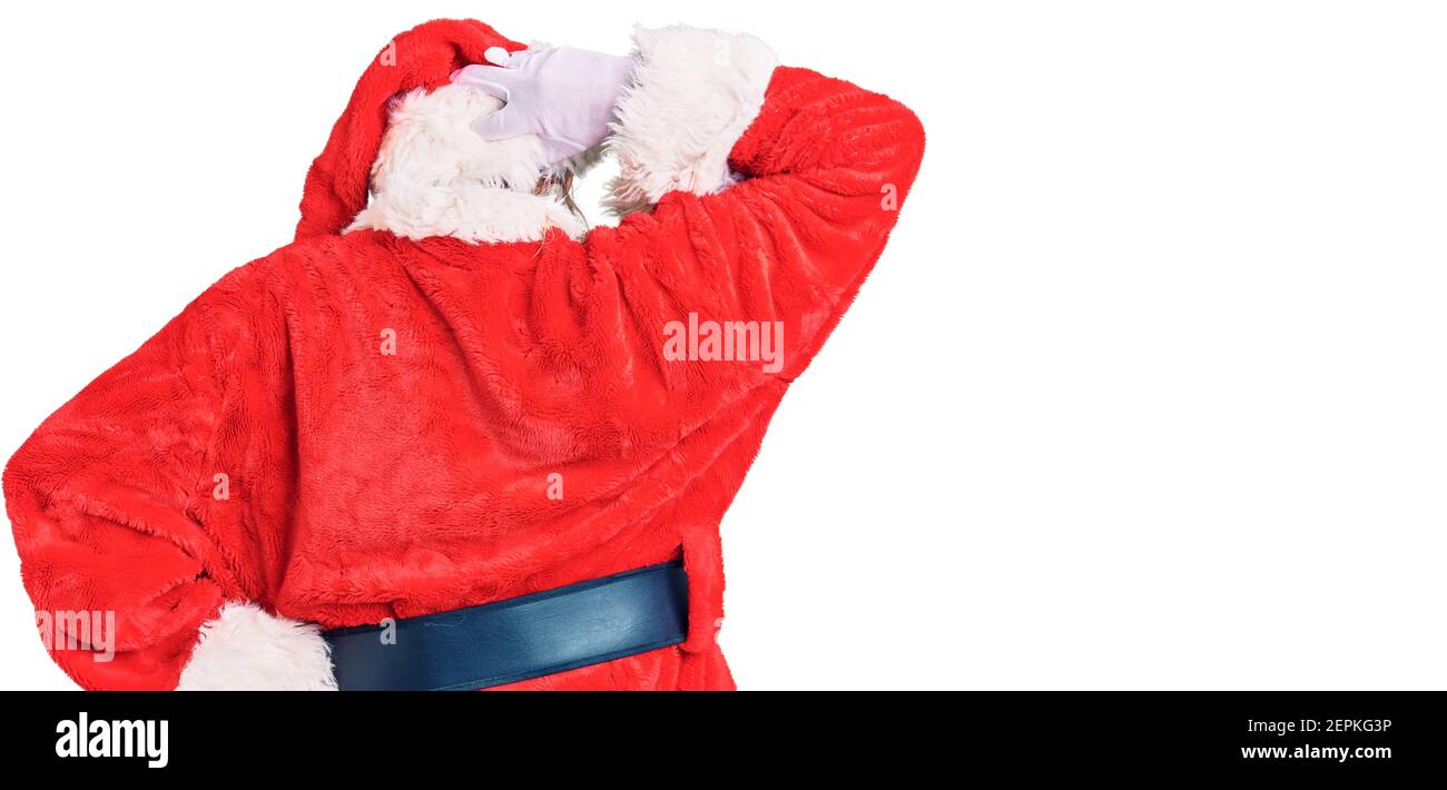 Old senior man with grey hair and long beard wearing traditional santa ...