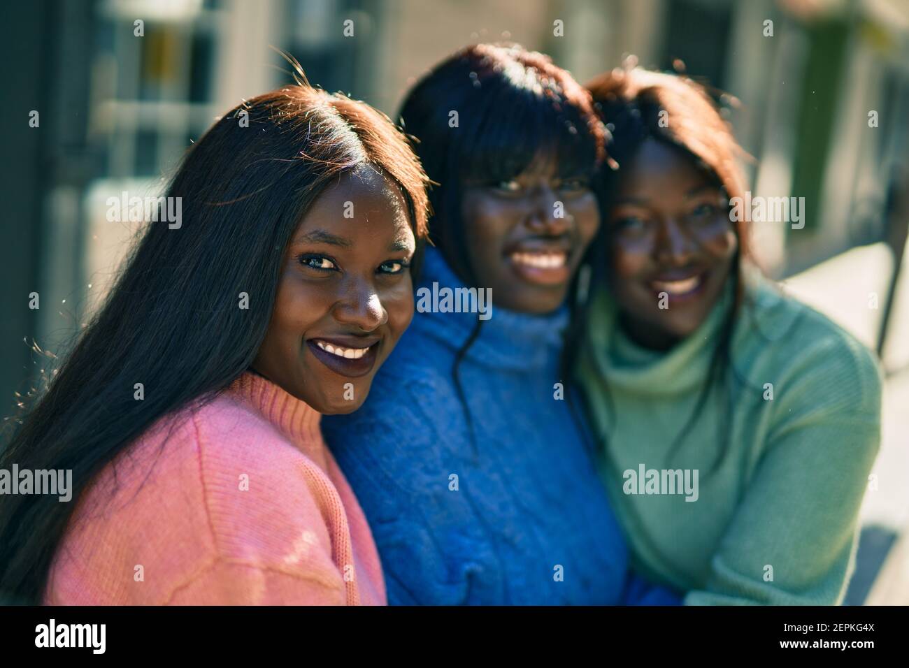 Three african american friends smiling happy hugging at the city Stock ...