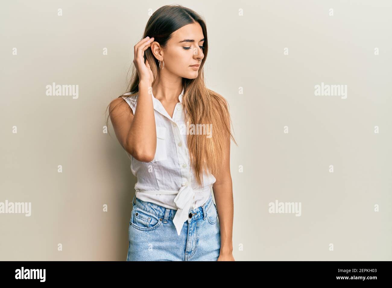 Beautiful young woman standing confident looking at the camera Stock ...