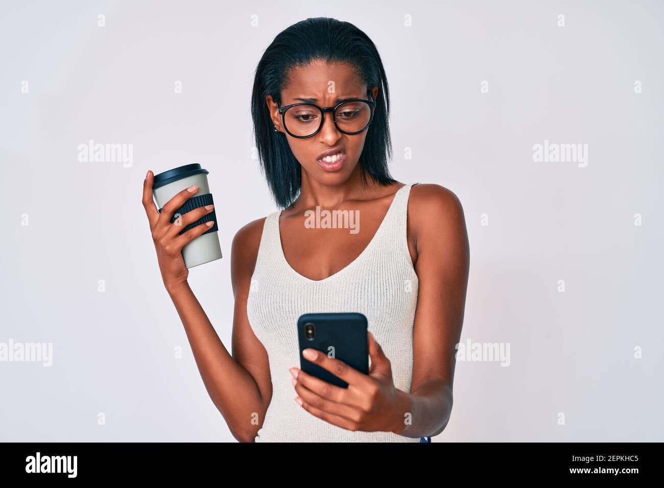 Young african american woman holding takeaway cup of coffee using ...