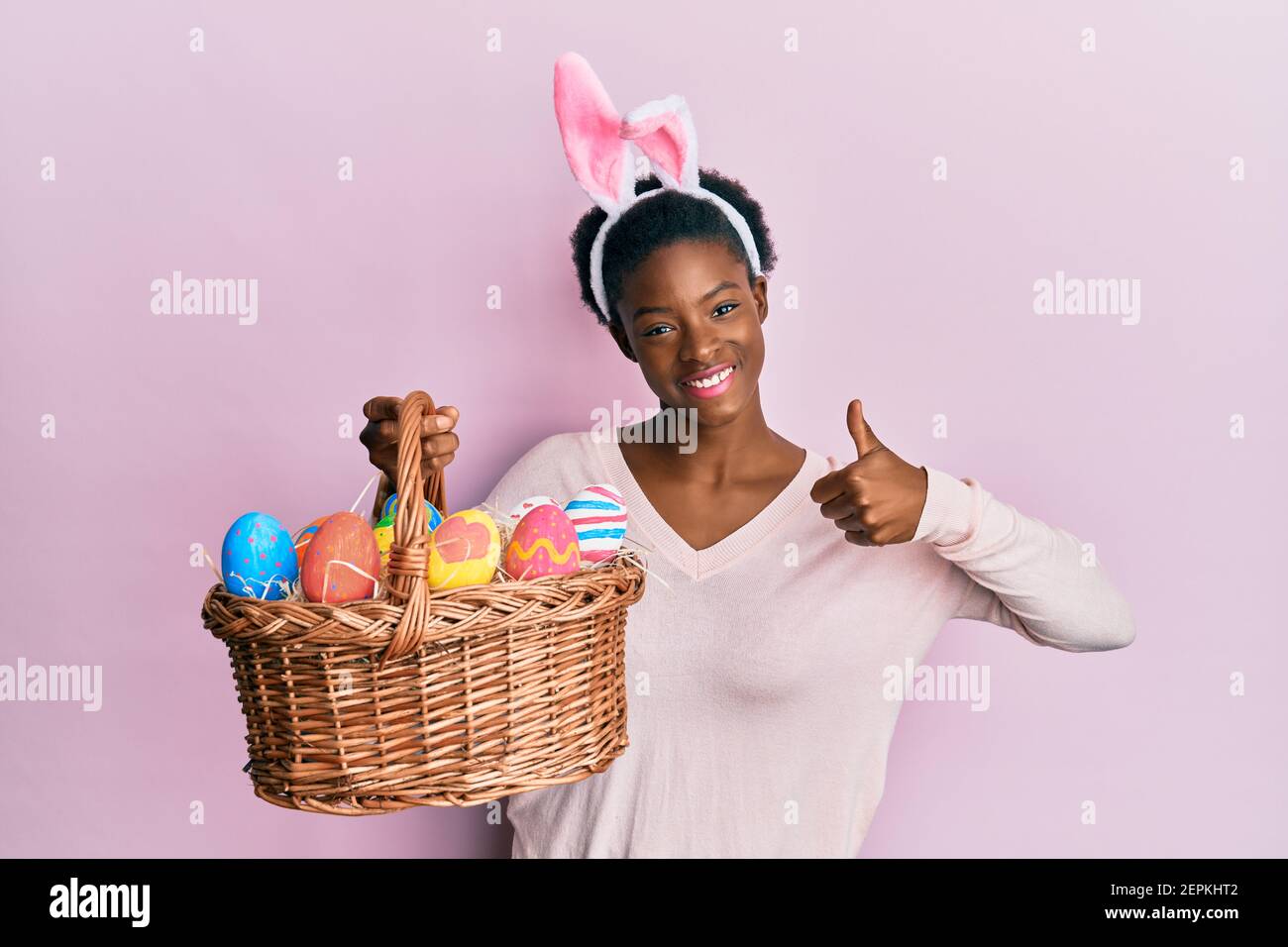Young african american girl wearing cute easter bunny ears holding ...
