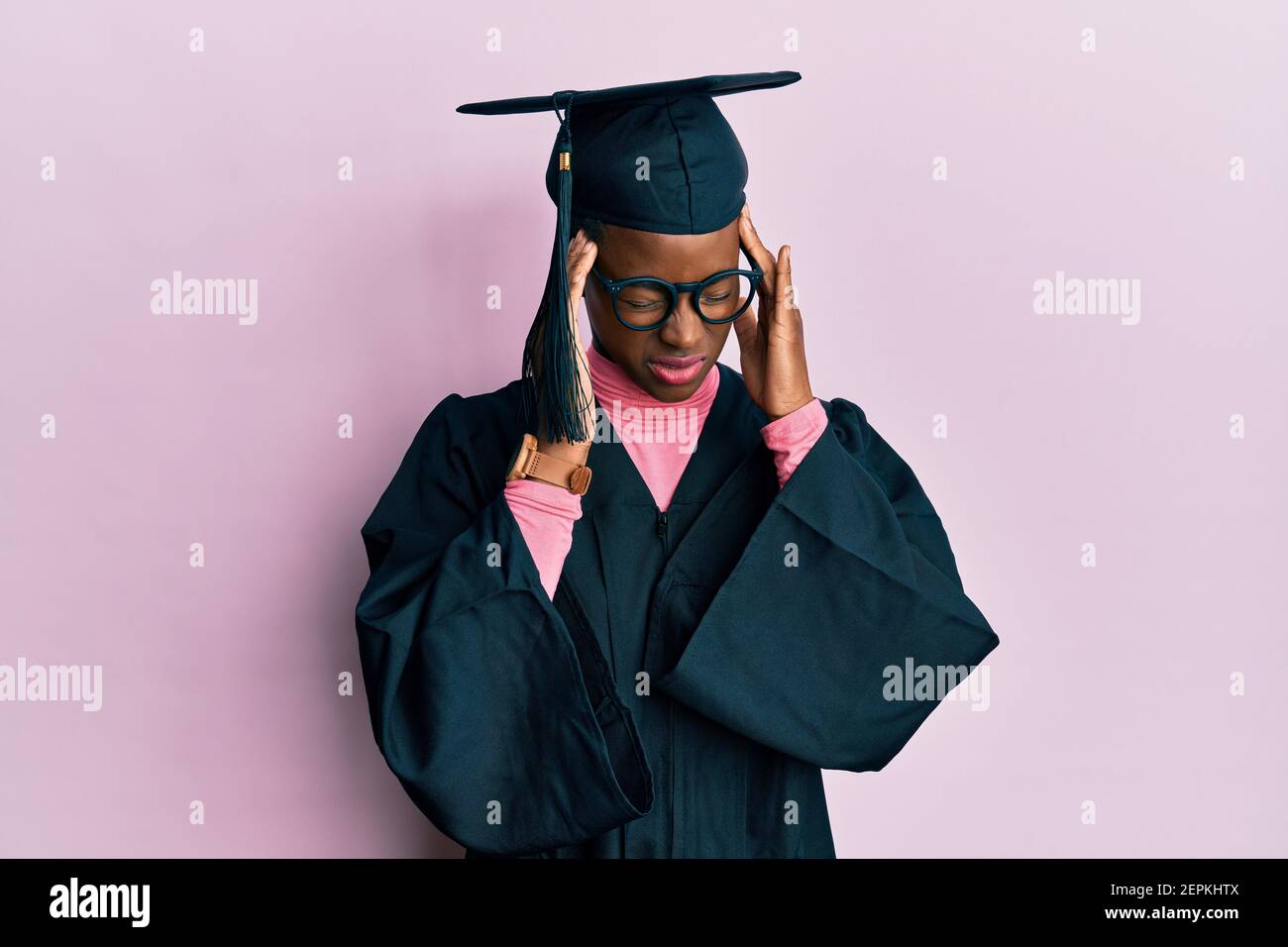 Young african american girl wearing graduation cap and ceremony robe ...