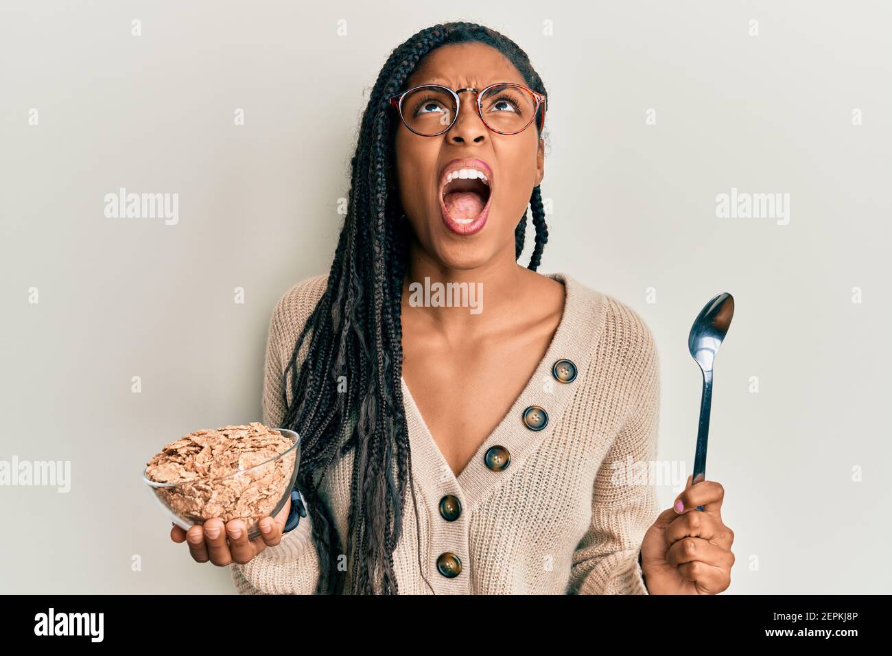 African american woman with braids eating healthy whole grain cereals ...