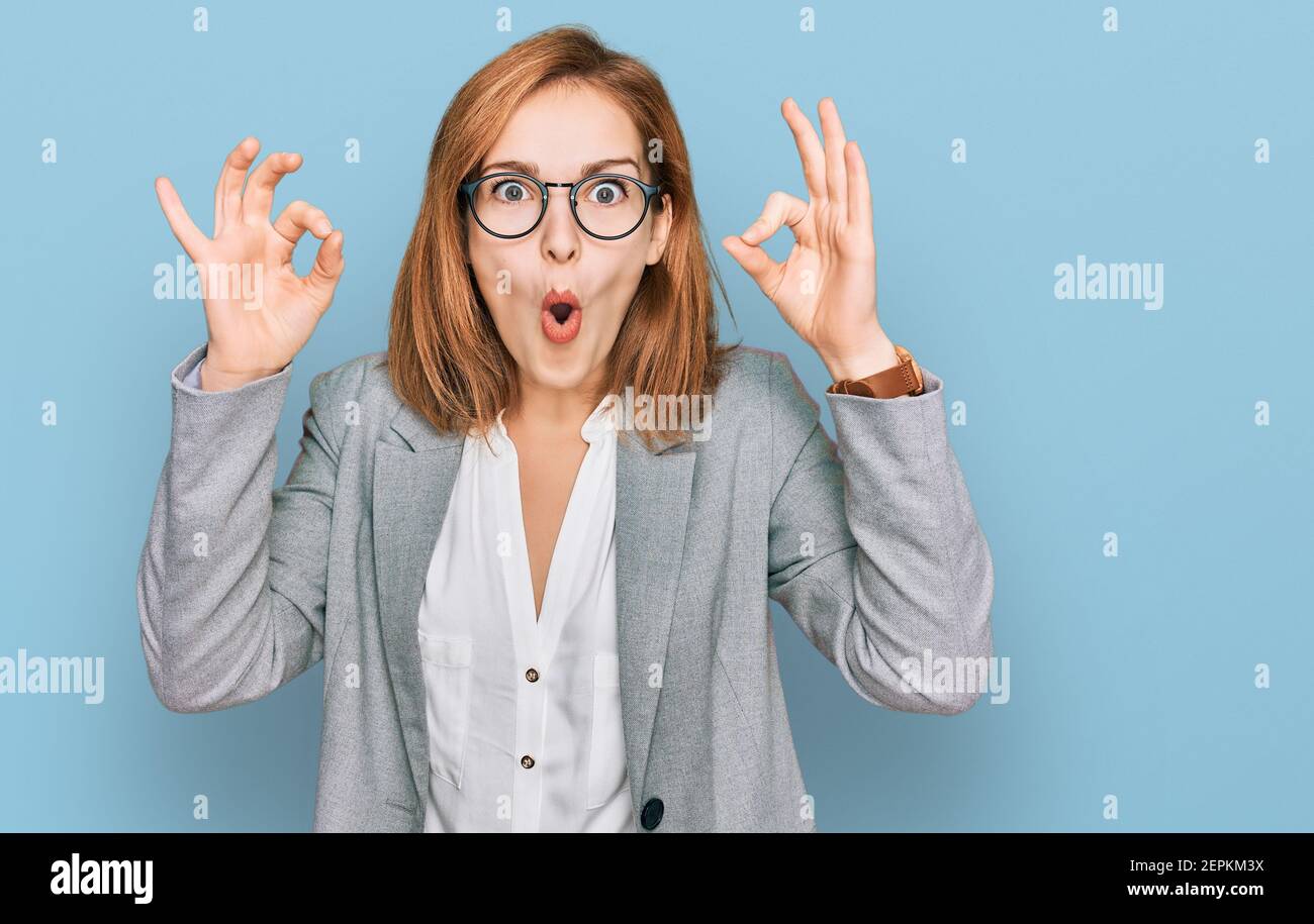 Young caucasian woman wearing business style and glasses looking ... Young caucasian woman wearing business style and glasses looking ...