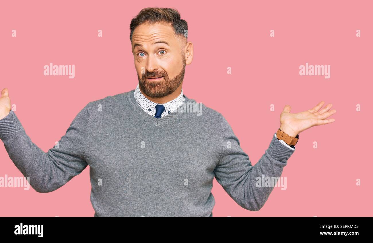 Handsome middle age man wearing business clothes clueless and confused ...