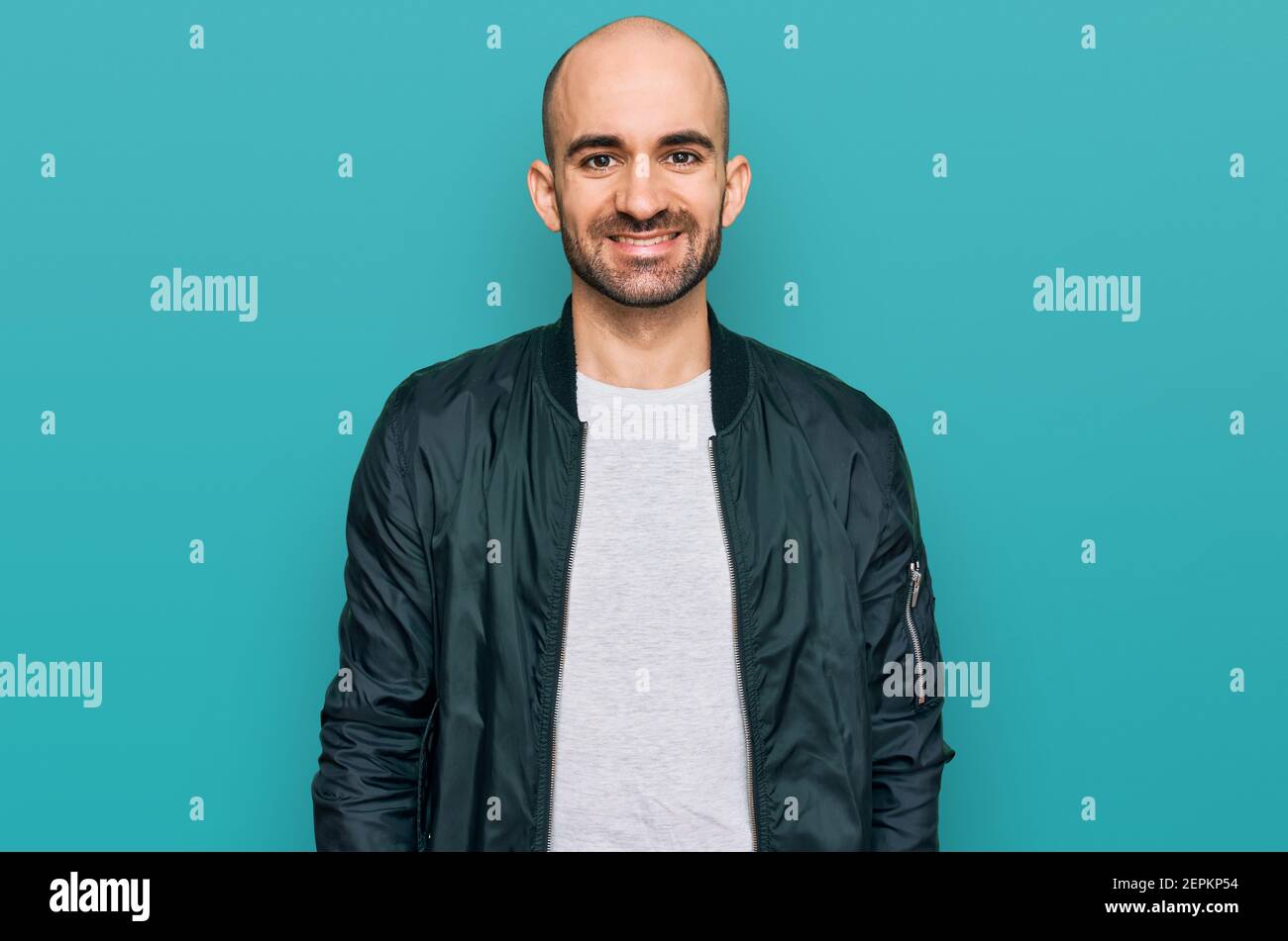 Young hispanic man wearing casual clothes with a happy and cool smile ...