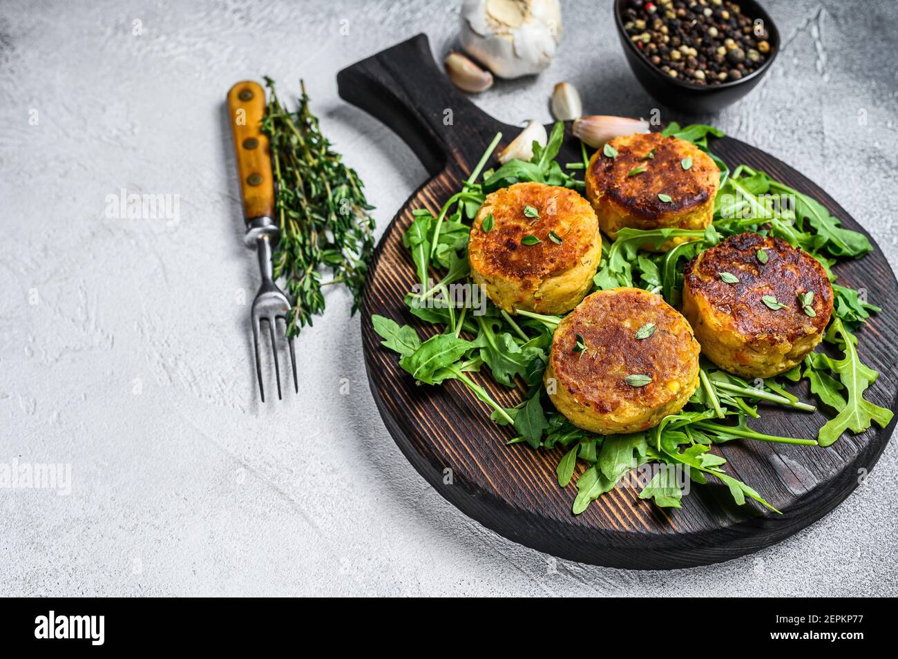 Veggie patty cutlet with lentils, vegetables and arugula. White ...