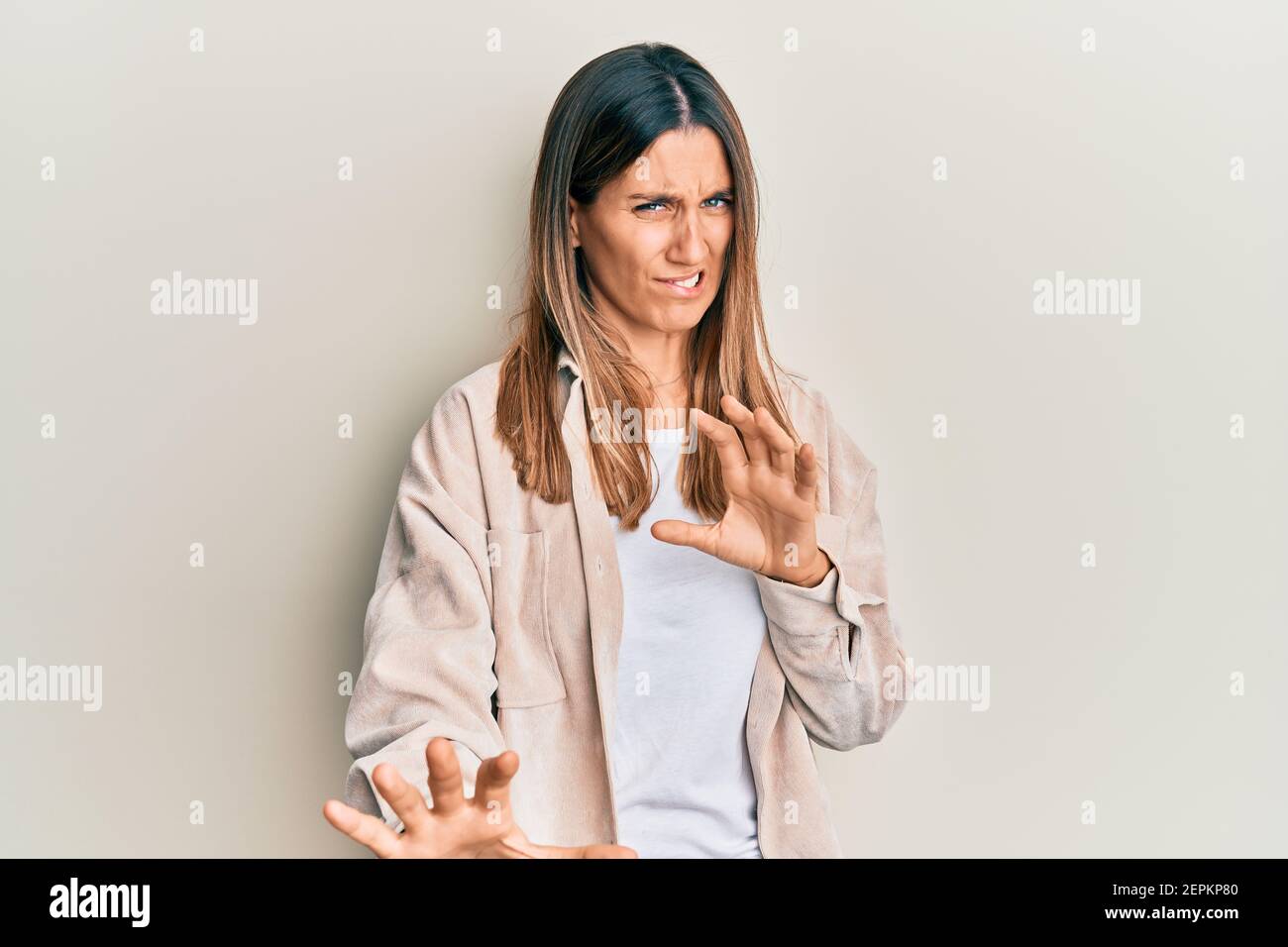 Brunette young woman wearing casual clothes disgusted expression ...