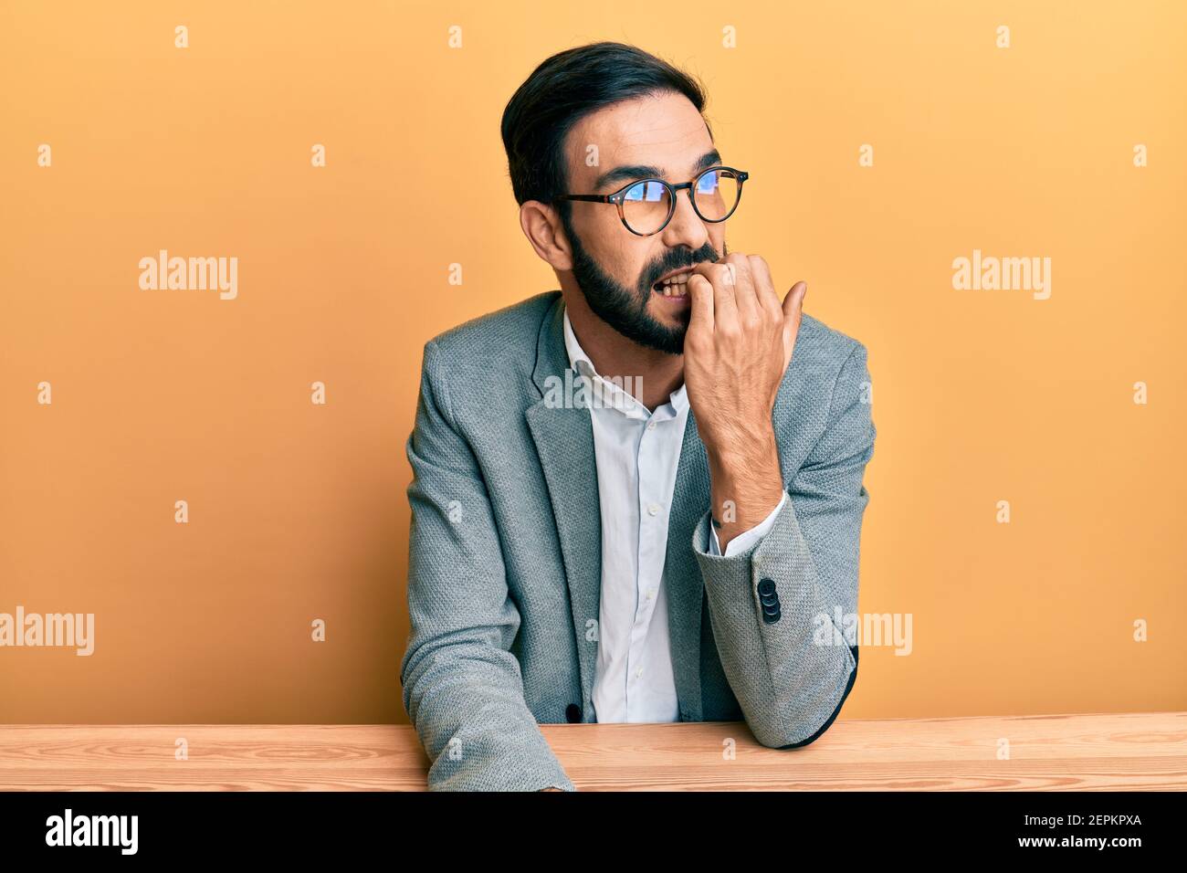 Young hispanic man working at the office looking stressed and nervous ...