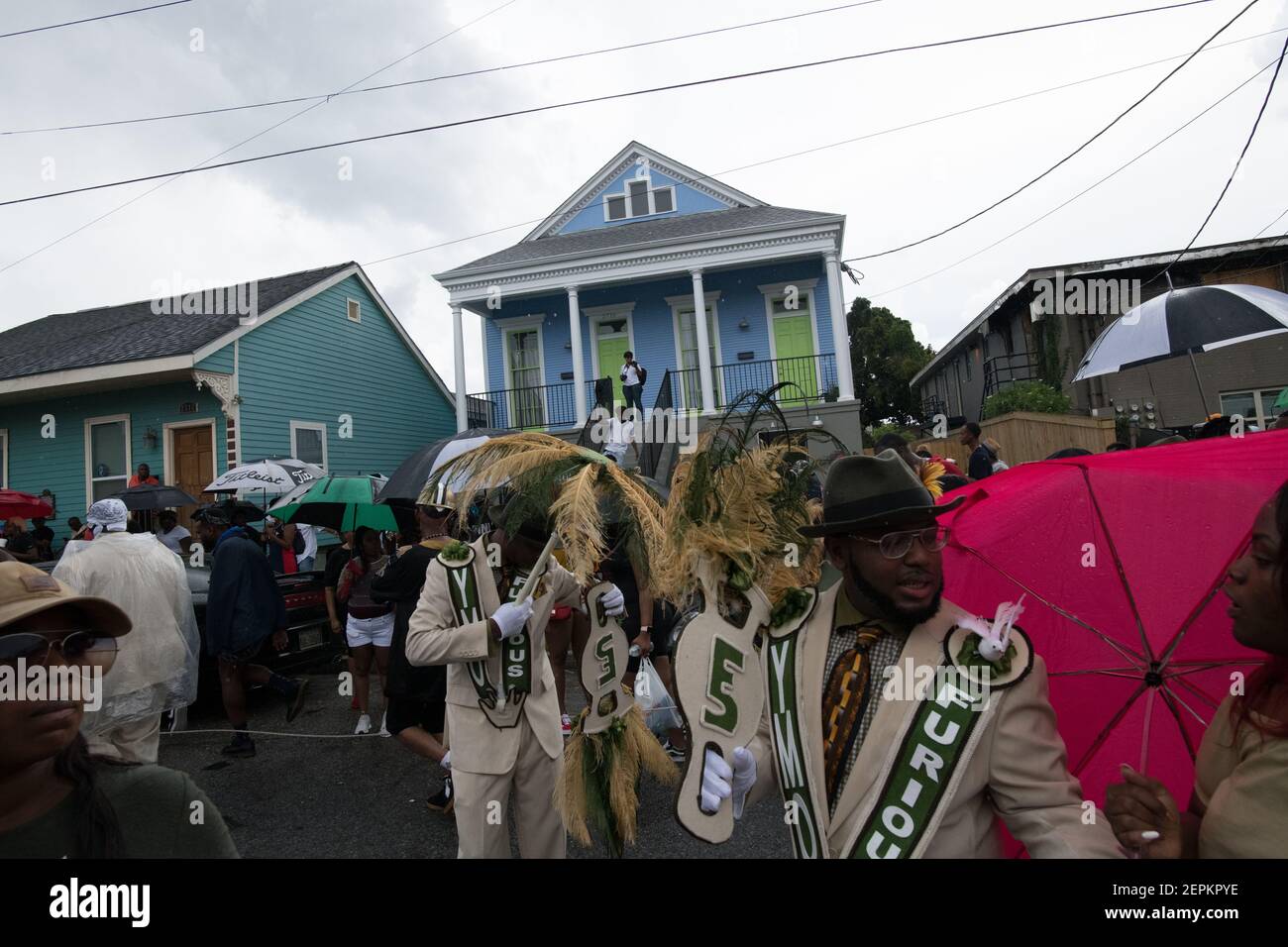 A vibrant second line parade marches past stately Uptown mansions in ...