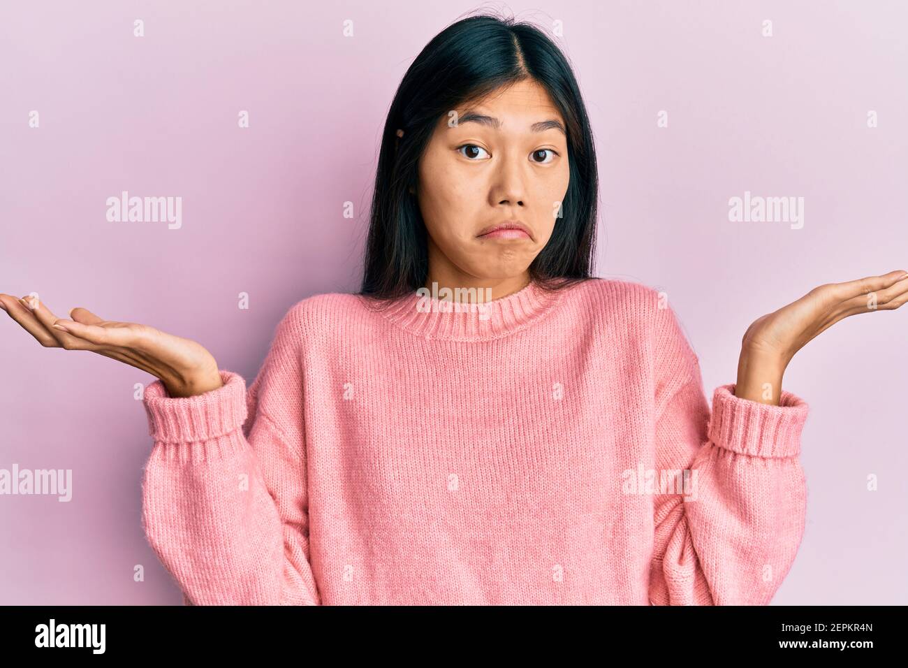 Young chinese woman wearing casual clothes clueless and confused with ...