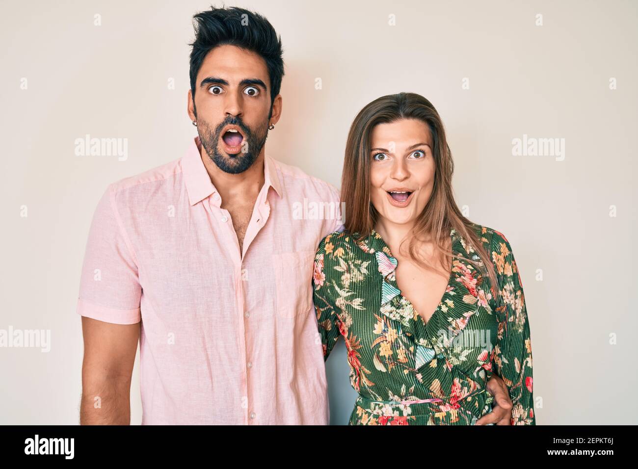 Beautiful young couple of boyfriend and girlfriend together afraid and ...