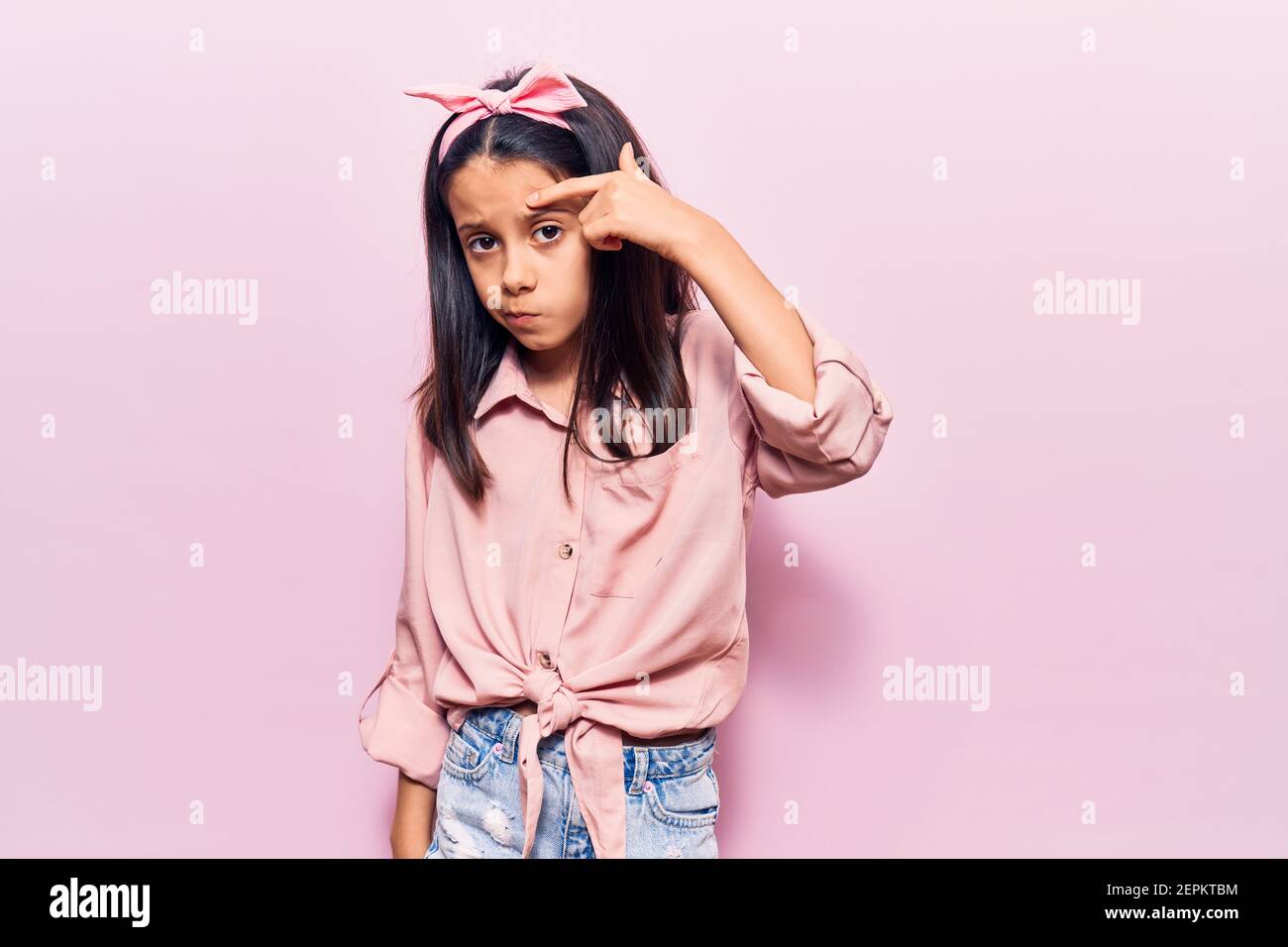 Beautiful child girl wearing casual clothes pointing unhappy to pimple ...