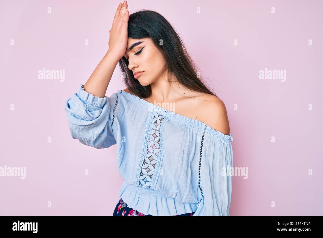 Brunette teenager girl wearing casual clothes surprised with hand on ...