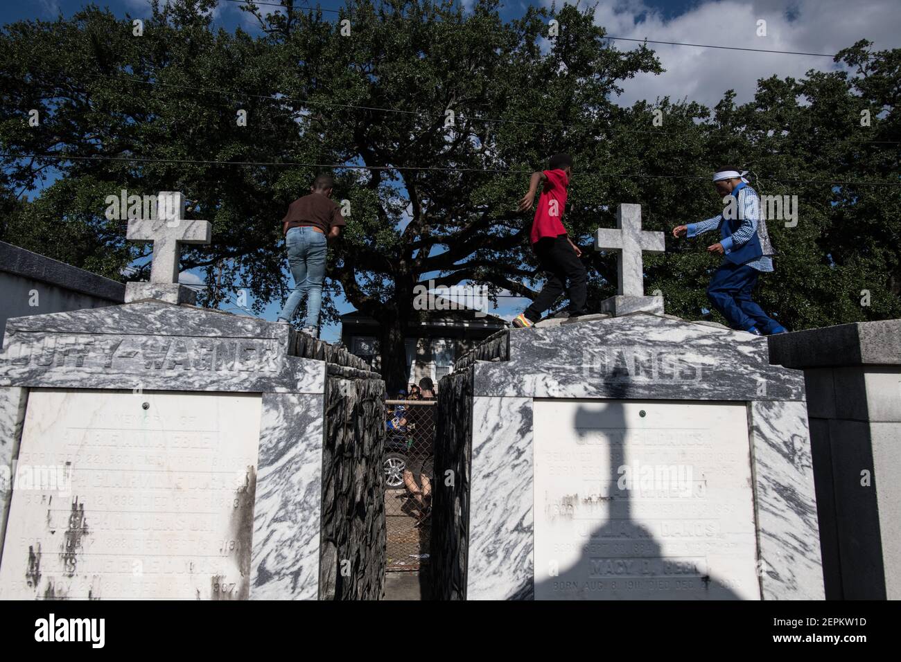 Young men dancing on graves and tombs in cemetery during Prince of ...