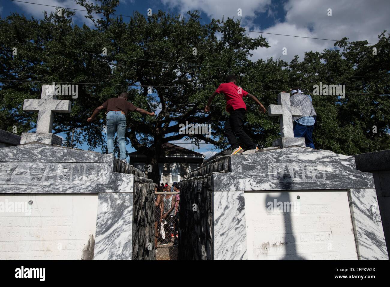 Young men dancing on graves and tombs in cemetery during Prince of ...