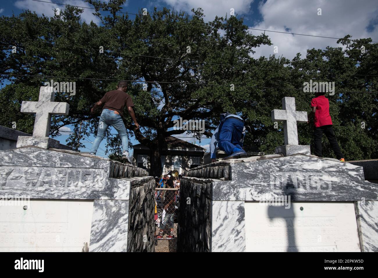 Young men dancing on graves and tombs in cemetery during Prince of ...