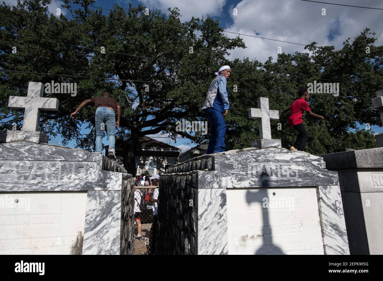 Young men dancing on graves and tombs in cemetery during Prince of ...