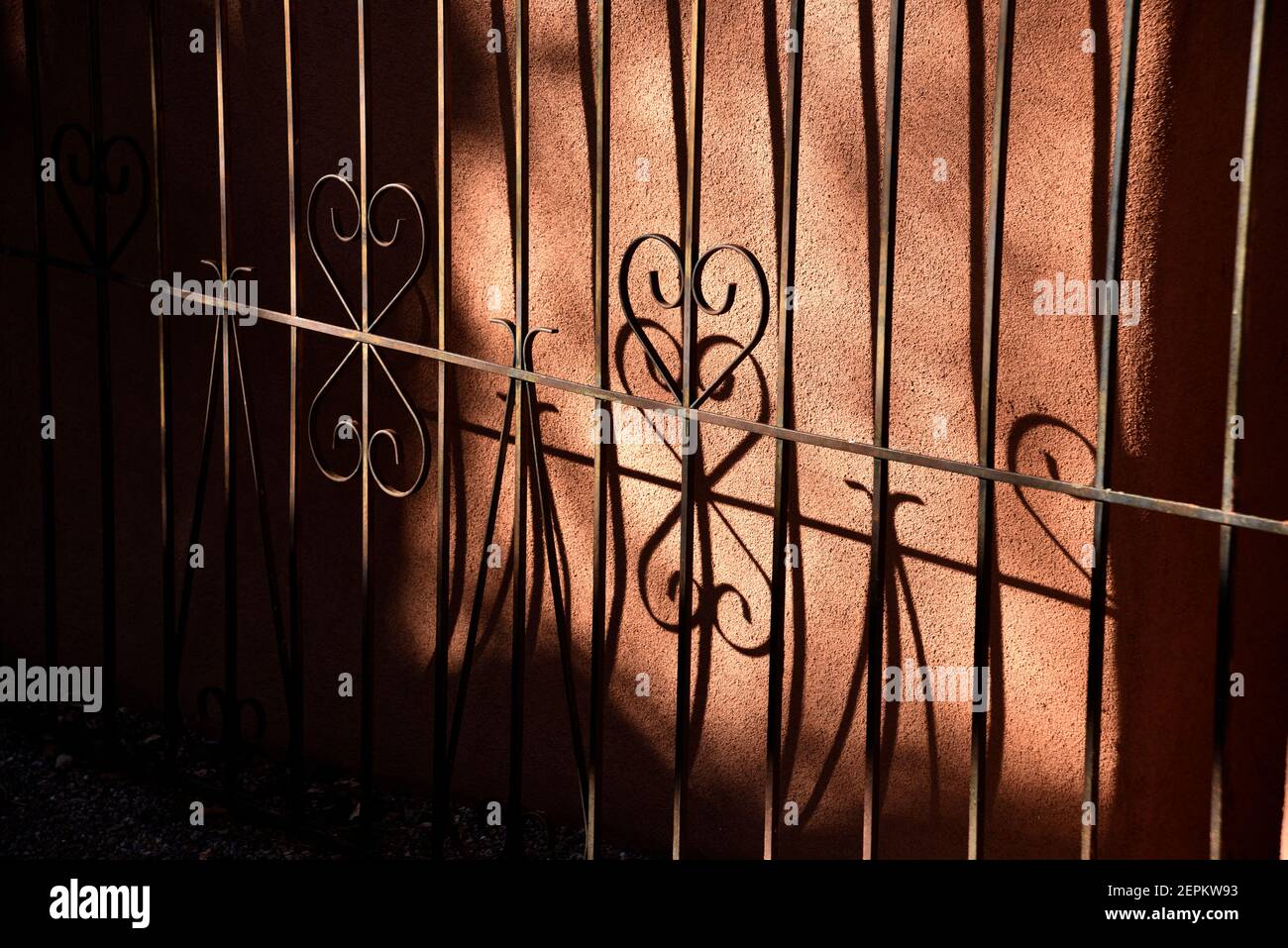 A hand-forged iron gate in front of an historic adobe home in Santa Fe ...