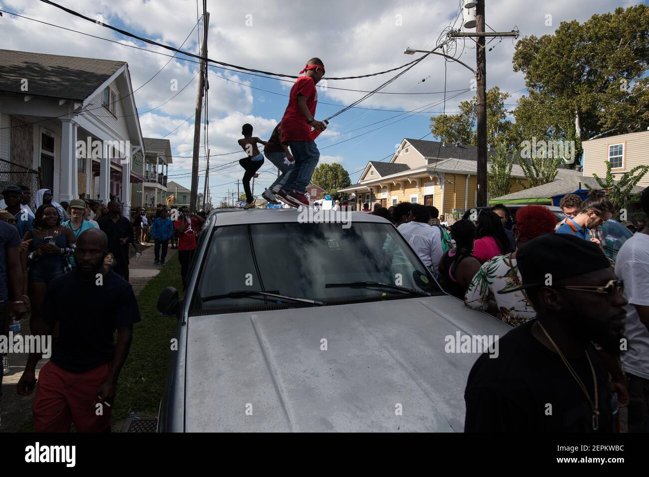 Kids dance atop a car during a vibrant second line parade in the Treme ...