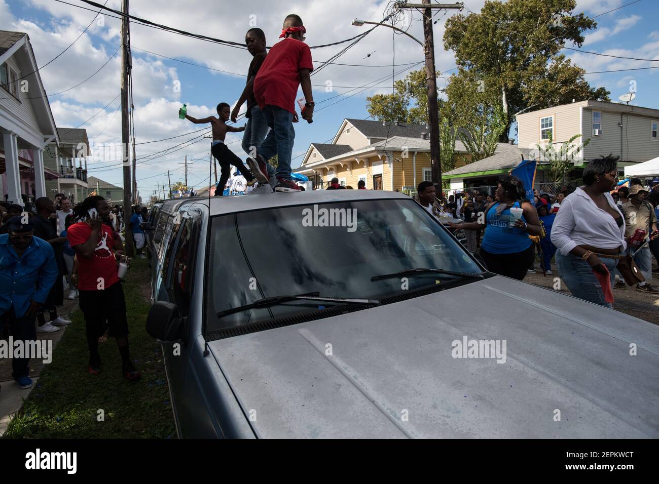Kids dance atop a car during a vibrant second line parade in the Treme ...