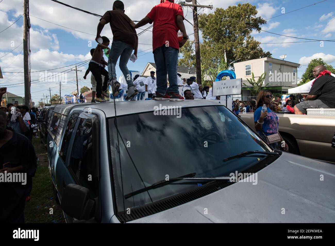 Kids dance atop a car during a vibrant second line parade in the Treme ...