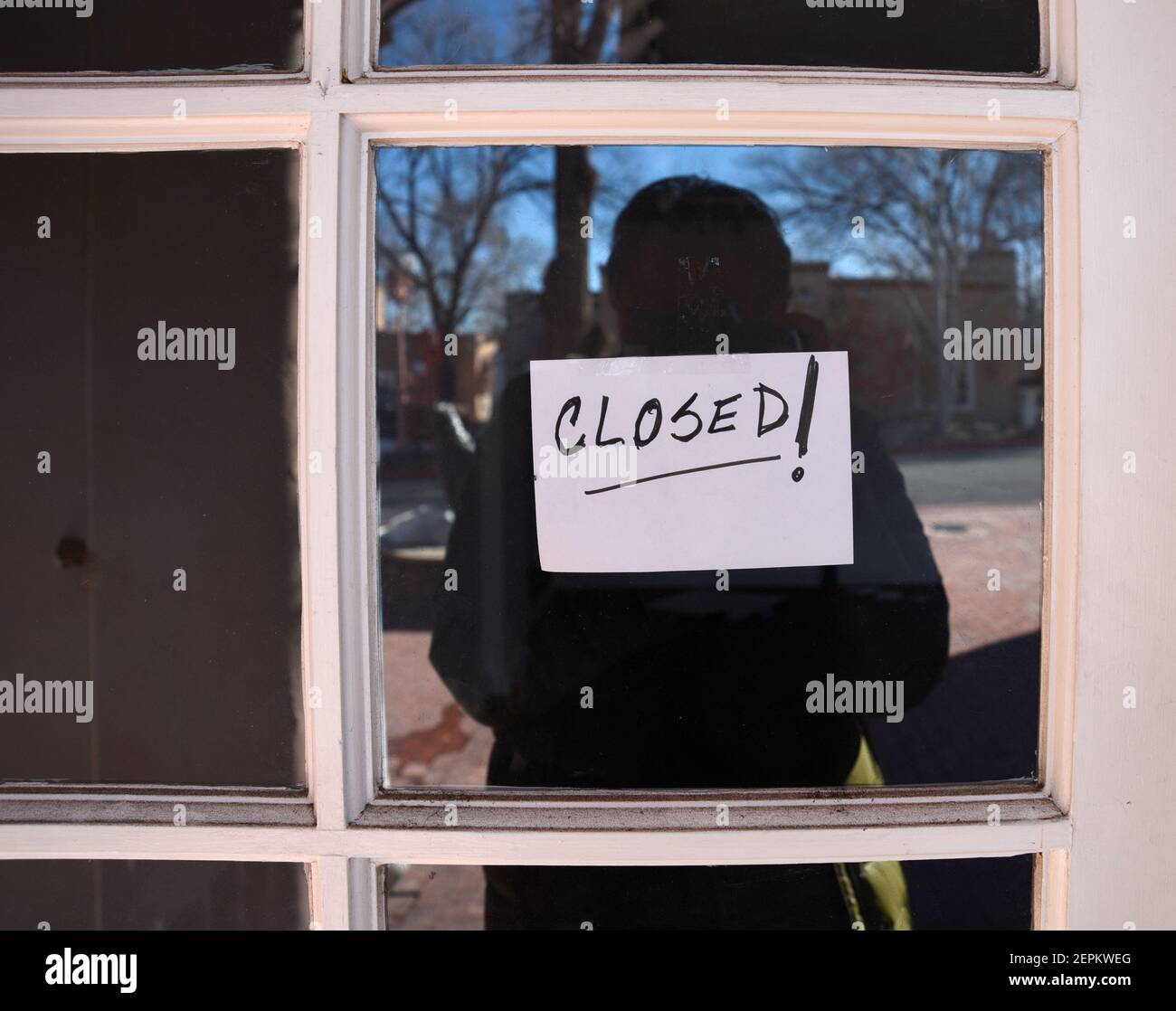 A hand-written Closed sign taped to the front door of a recently closed ...
