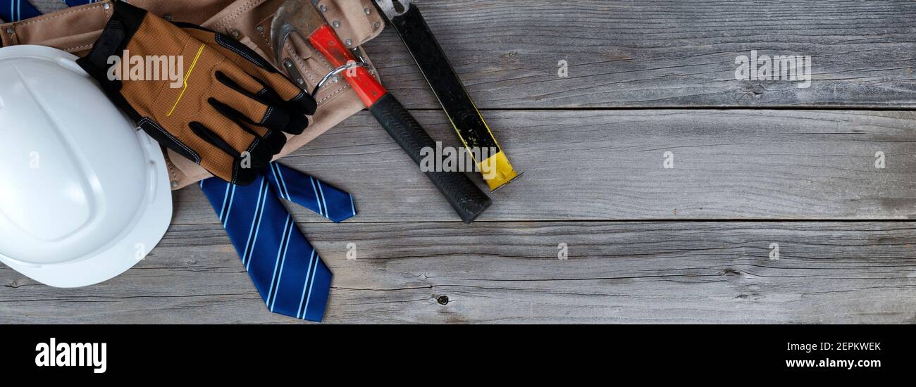 Blue striped necktie with construction labor items on aged wooden ...