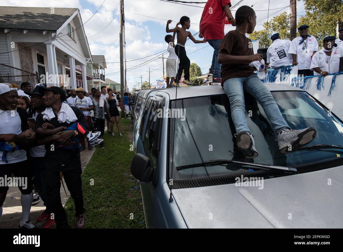 Kids dance atop a car during a vibrant second line parade in the Treme ...