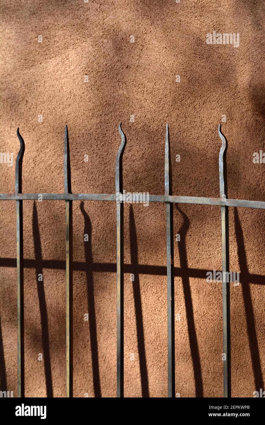 A hand-forged iron gate in front of an historic adobe home in Santa Fe ...