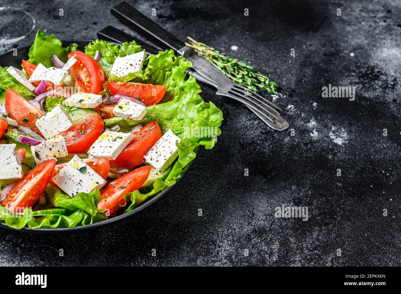 Fresh Greek salad with vegetables and feta cheese in a plate. Black ...