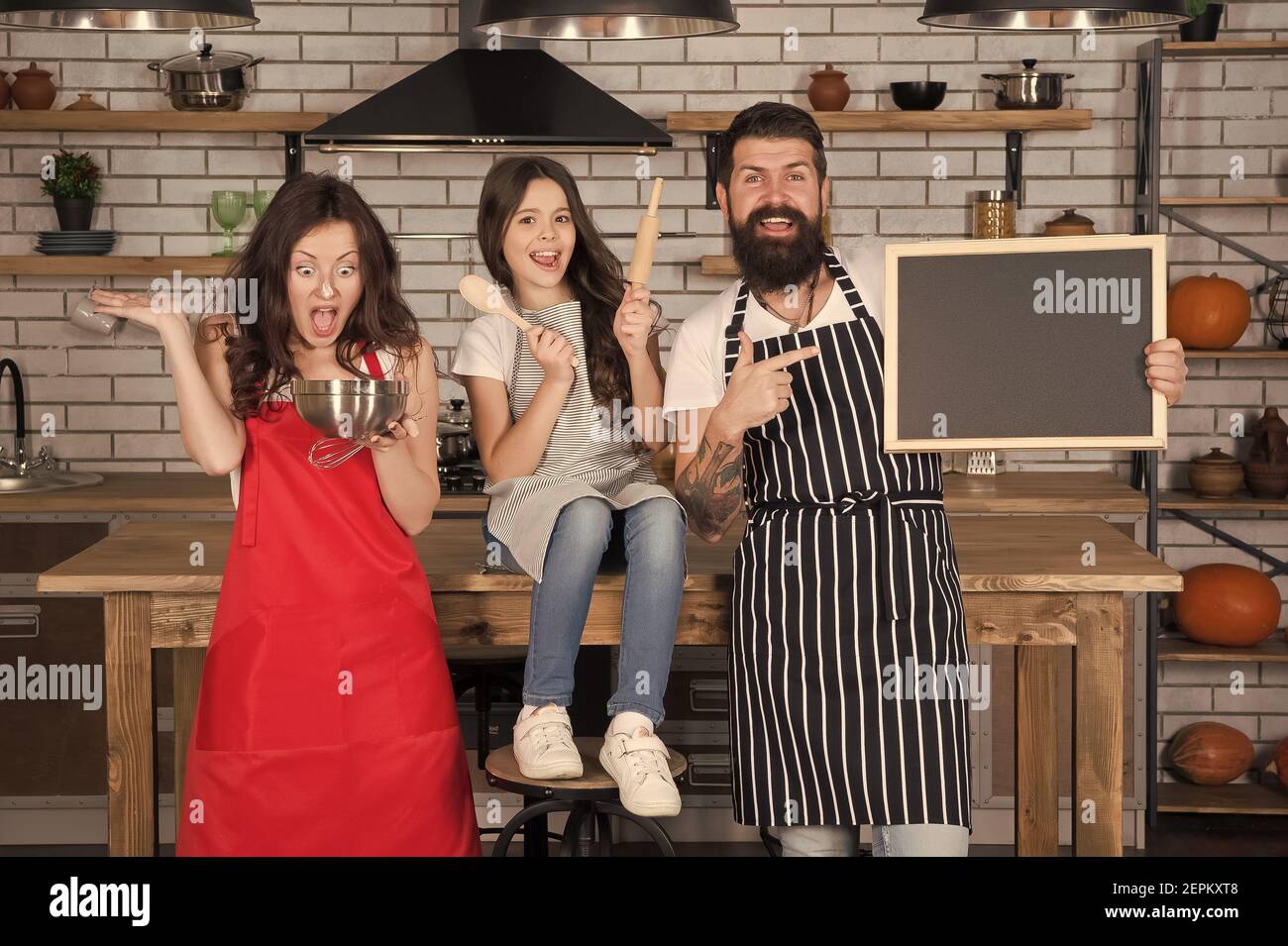 Mother and father teaching daughter how to cook. small girl with mom ...