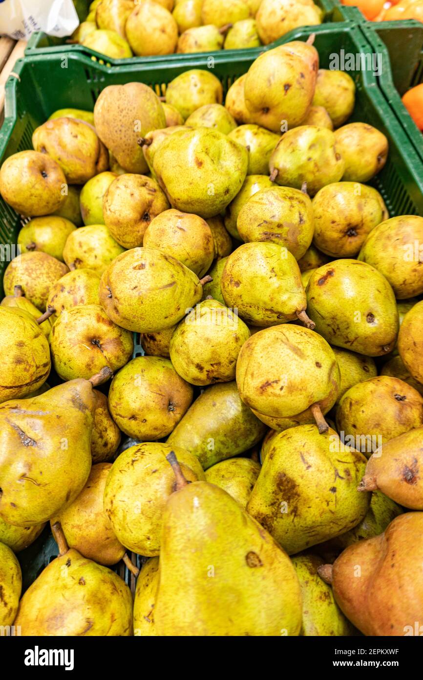 Yellow pears harvest. Pears in a basket on shelf in supermarket may use ...