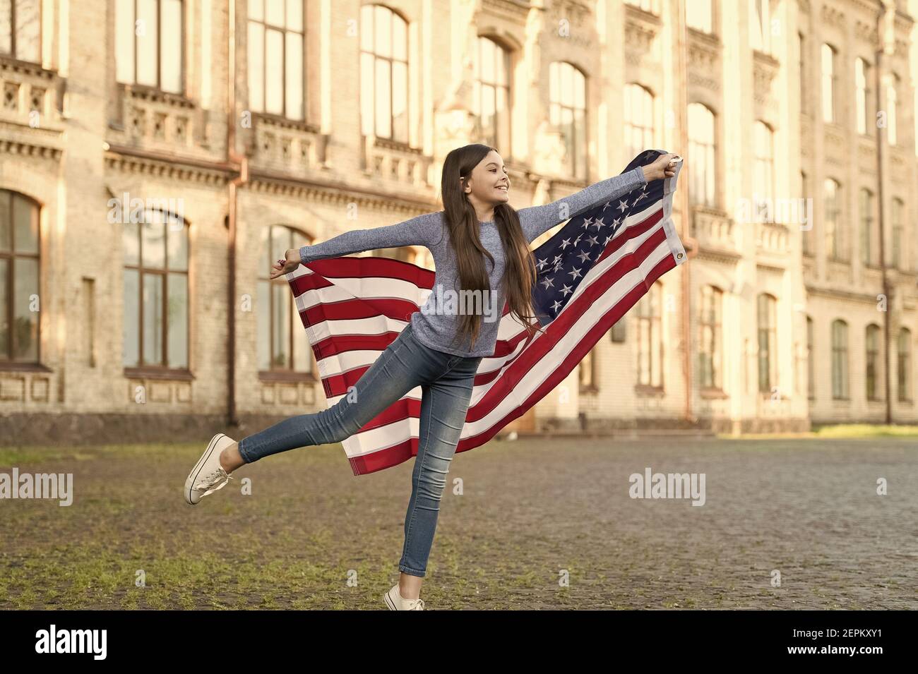Patriotic upbringing. Patriotic child hold american flag outdoors ...