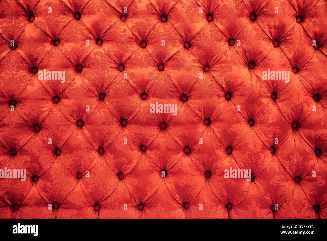 Close up background texture of scarlet red capitone genuine leather ...