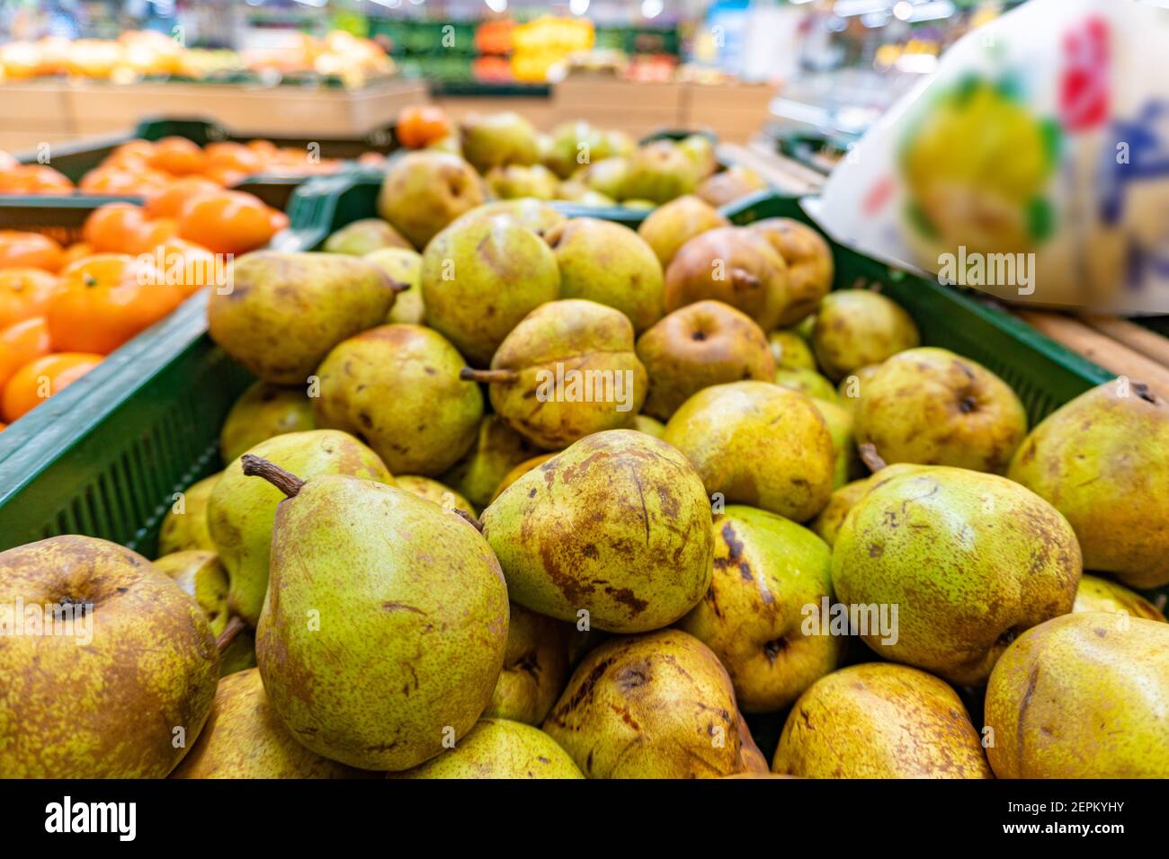 Green pears harvest. Fresh pears in a basket on shelf in supermarket ...