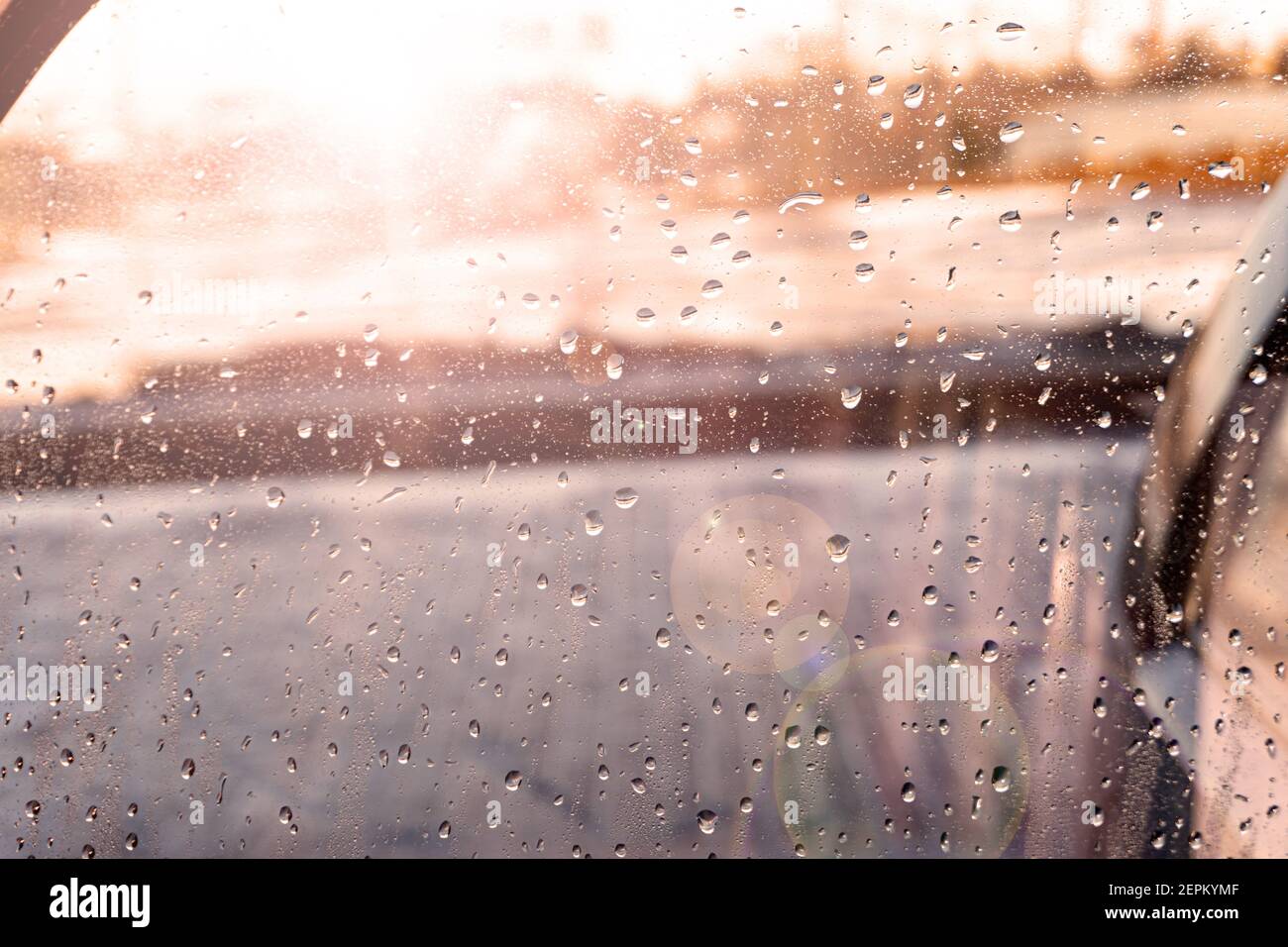 Water drops, rain sticking to car window glass with flare Stock Photo ...