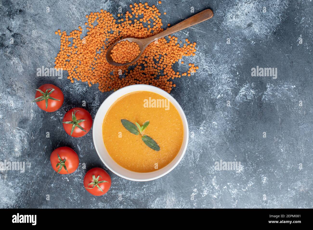 A white bowl of lentil soup with tomatoes and wooden spoons Stock Photo ...