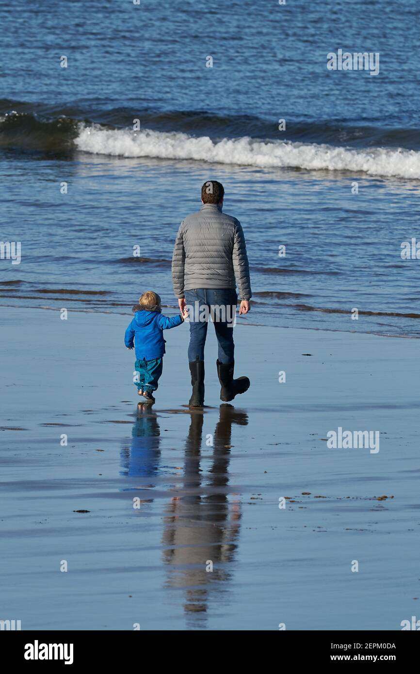 Hopeman, Moray, UK. 27th Feb, 2021. UK. This is father and son out on ...