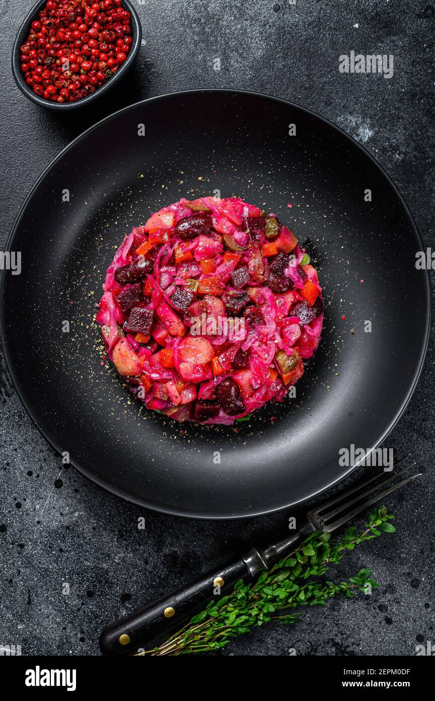 Vegetarian vinaigrette beet vegetable salad. Black background. Top view ...