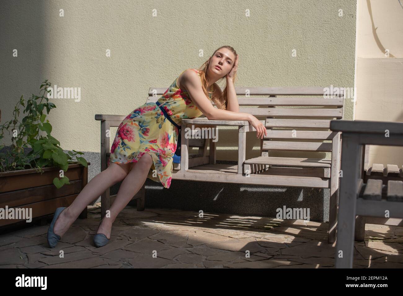 girl in dress walks through the old town in the summer. Beautiful ...