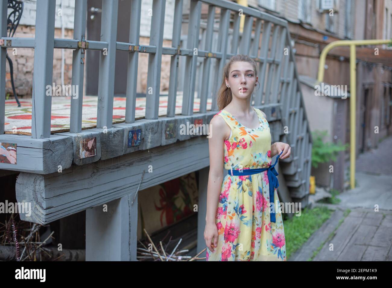 girl in dress walks through the old town in the summer. Beautiful ...
