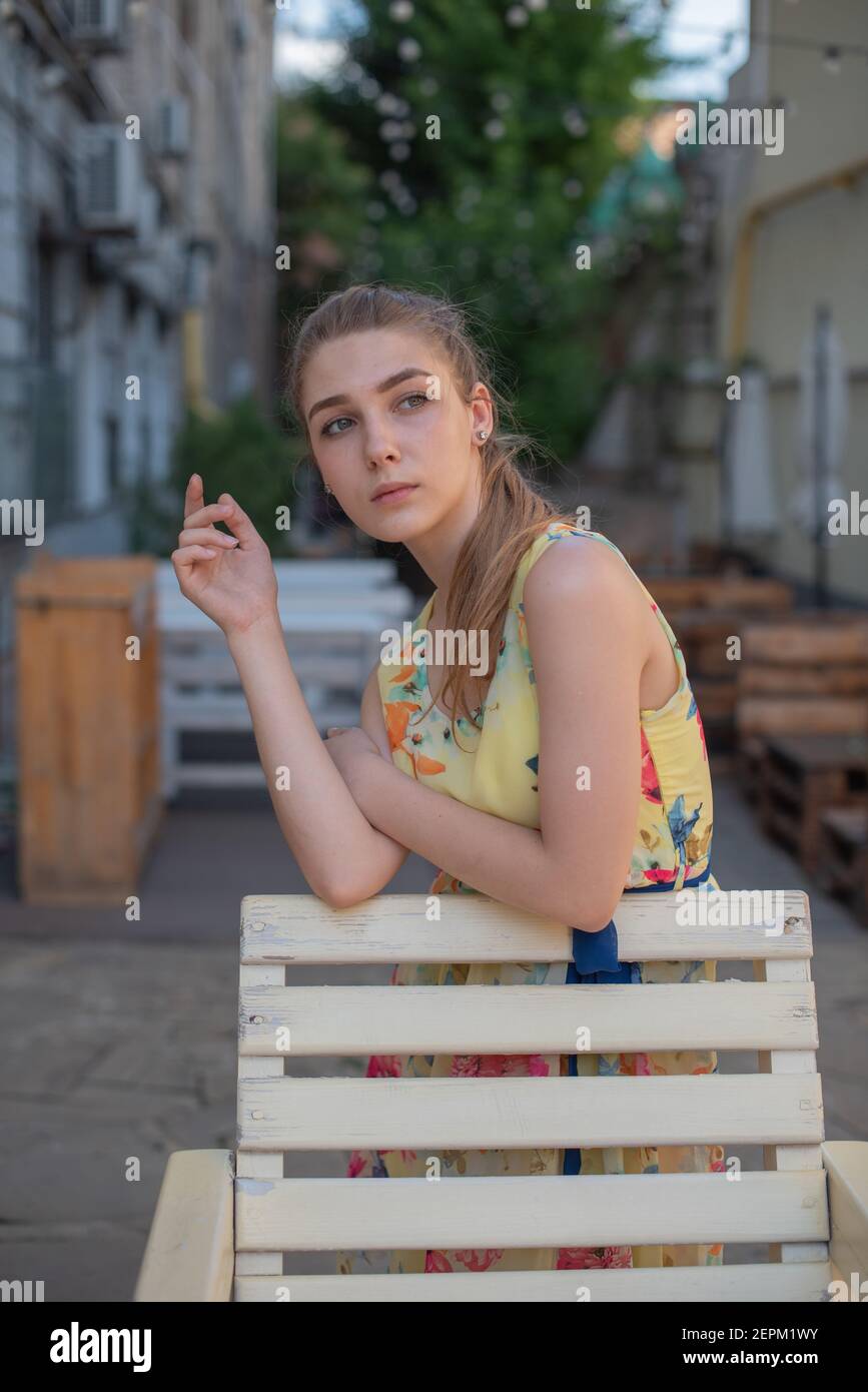 girl in dress walks through the old town in the summer. Beautiful ...