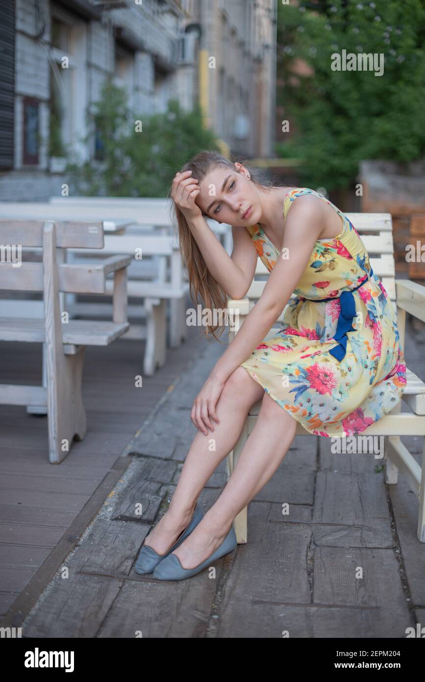 girl in dress walks through the old town in the summer. Beautiful ...