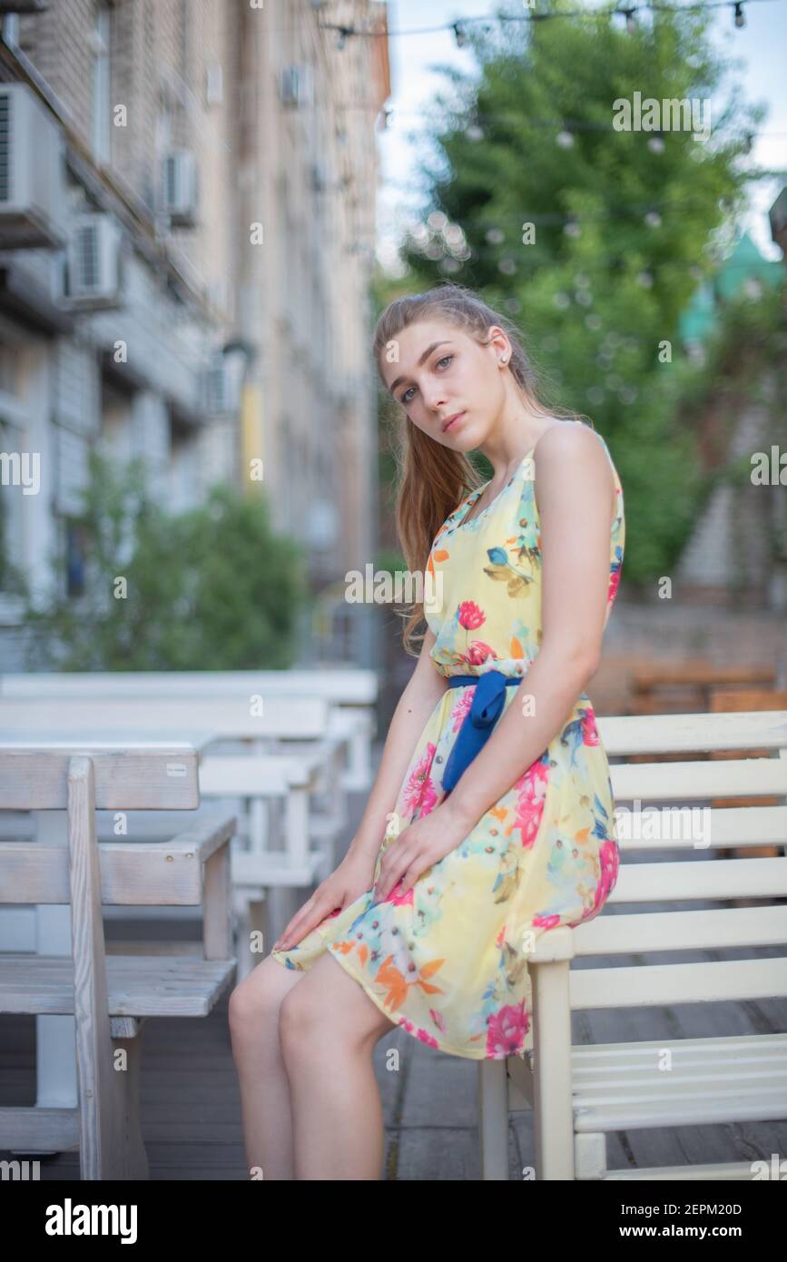 girl in dress walks through the old town in the summer. Beautiful ...