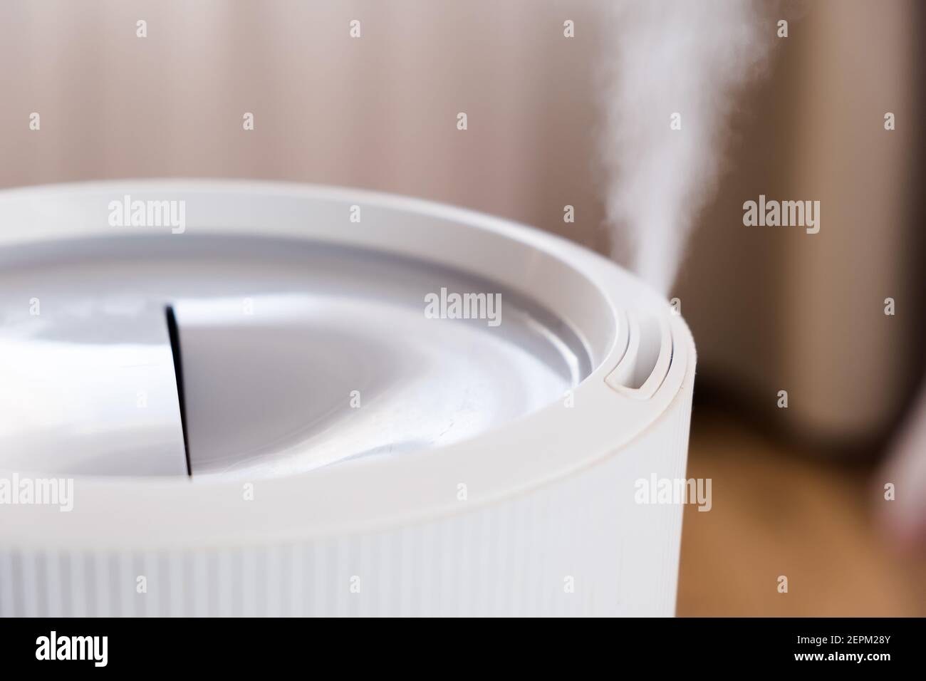 Steam from modern air humidifier, aroma oil diffuser at home. Improving ...