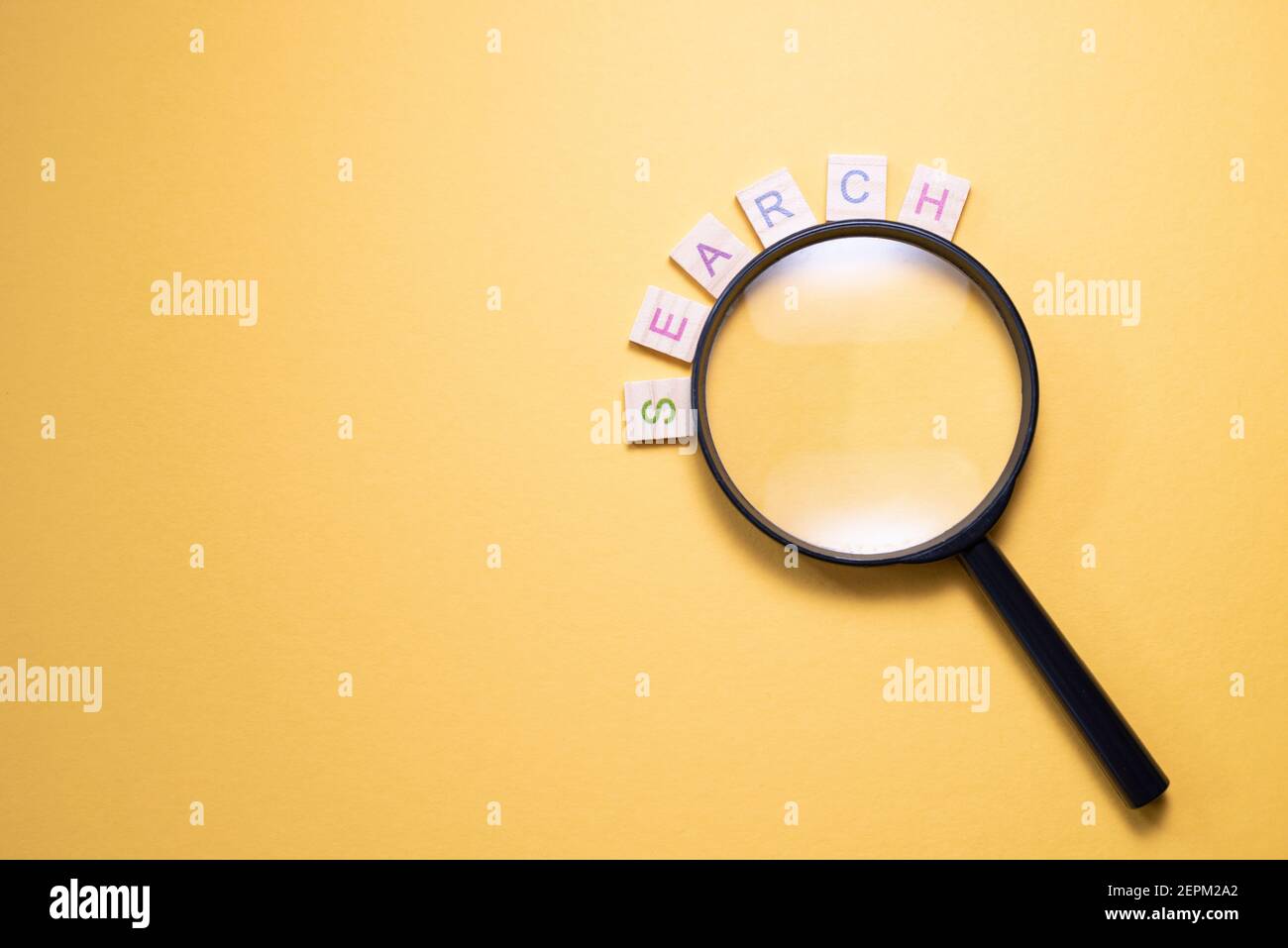 Magnifying glass and wooden alphabet tiles letter SEARCH. Concept of ...