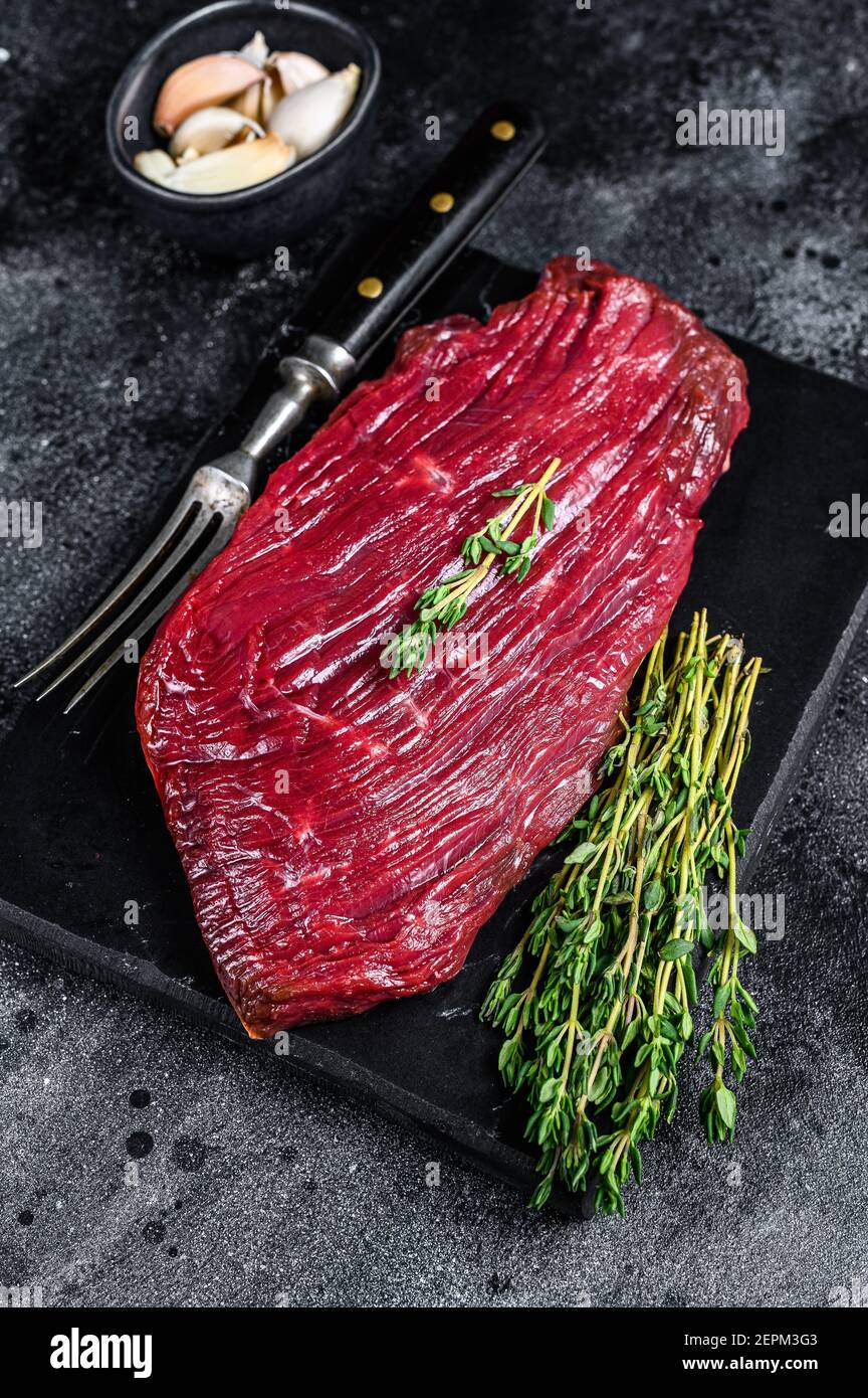 Venison raw steak from wild meat. Black background. Top view Stock ...